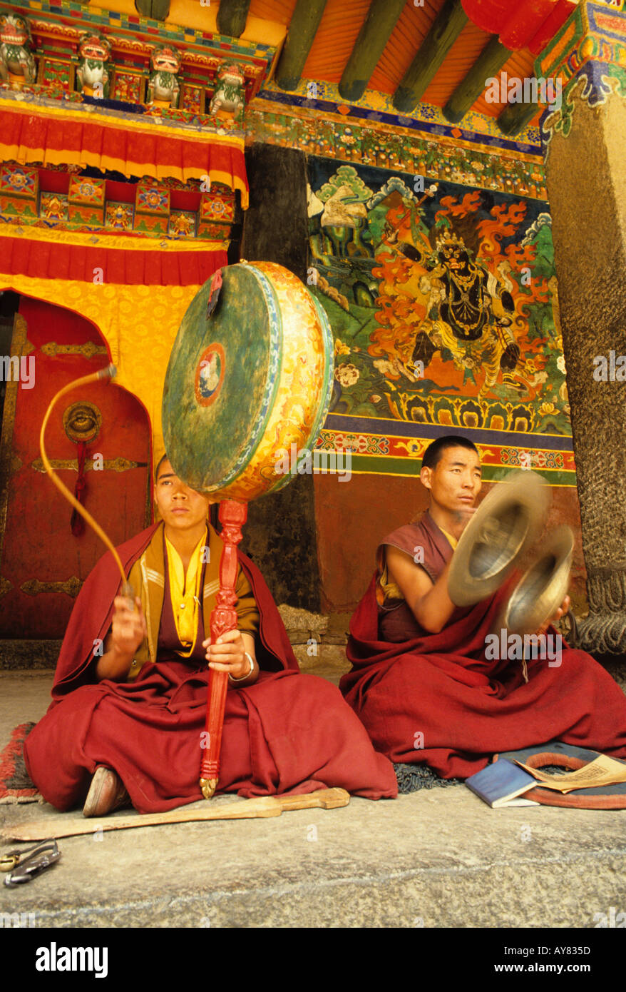 musician monks in Tibetan monastery playing traditional horns and drums ...