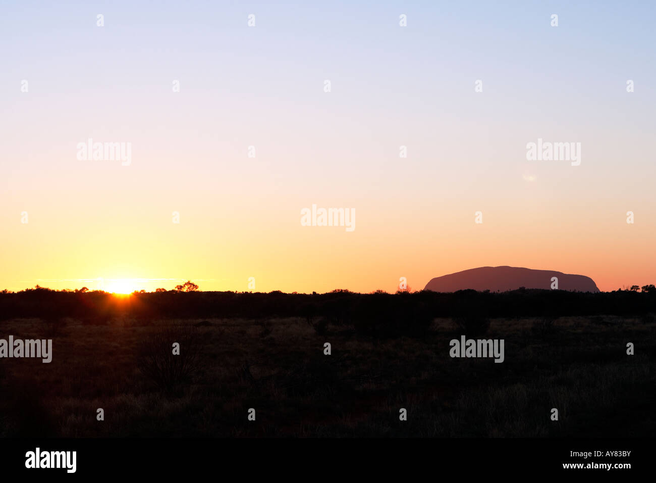 Sunrise over the sandstone of Ayers Rock, Uluru-Kata Tjuta National ...