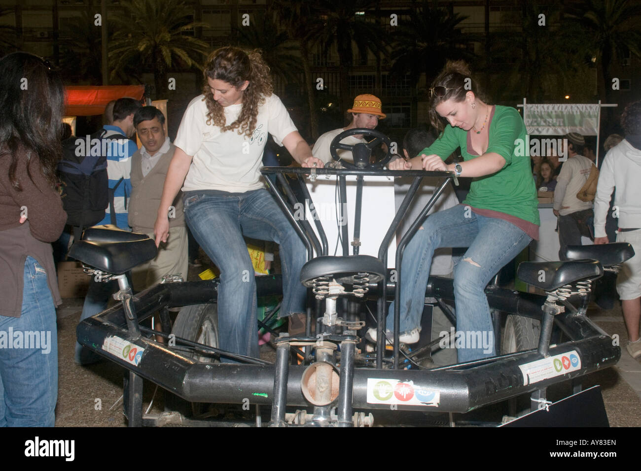 Cycling on converted bicycles connected to an electric generator as a ...