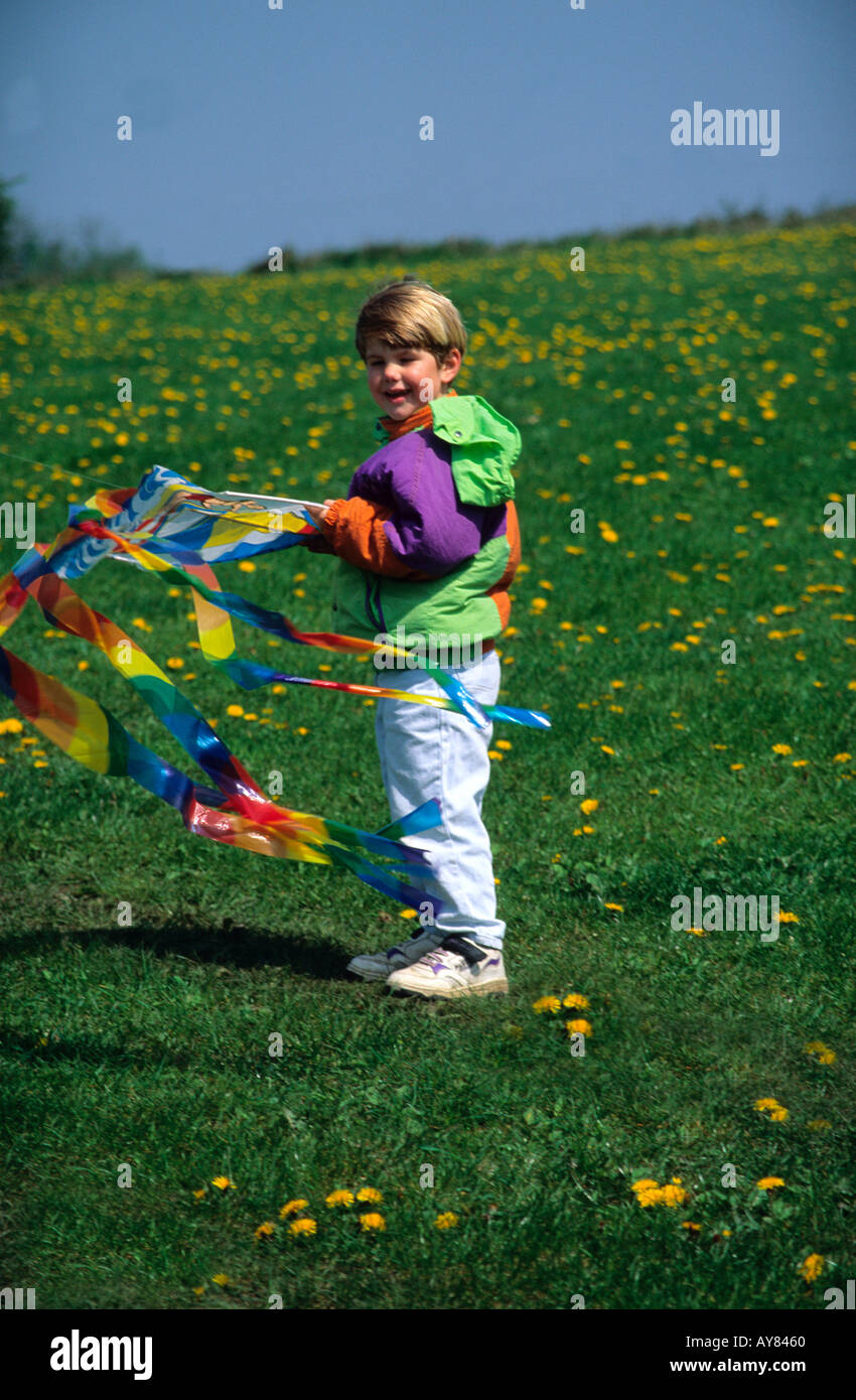blond smiling boy wearing multicolour anorak with a bright coloured ...
