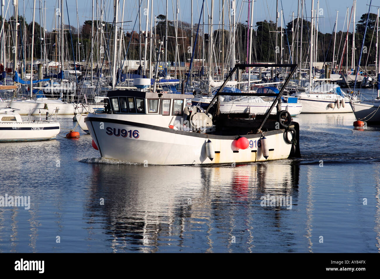 Local fishing boat entering Lymington River Stock Photo - Alamy