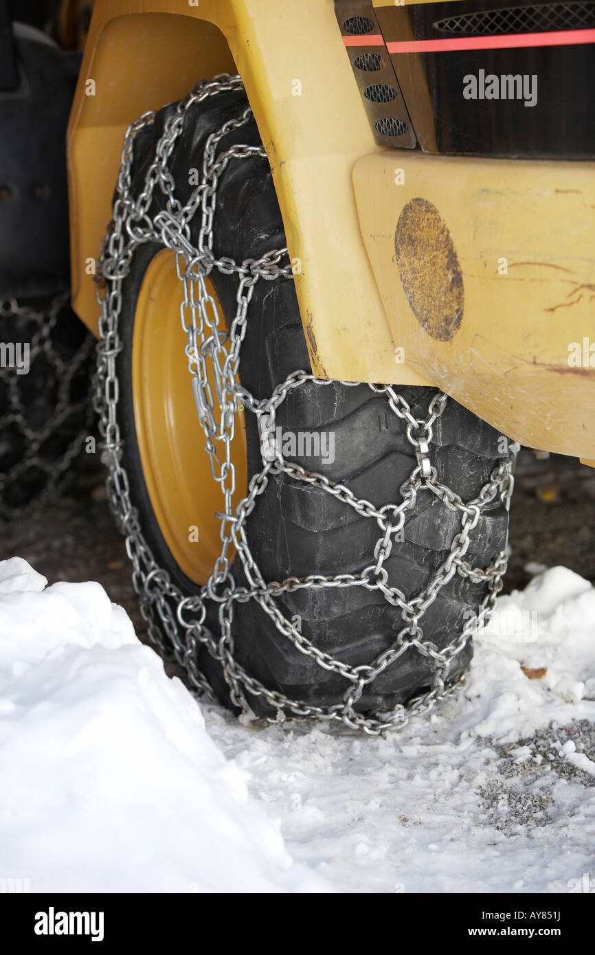 Snow chains, attached to snow plough tractor Stock Photo - Alamy