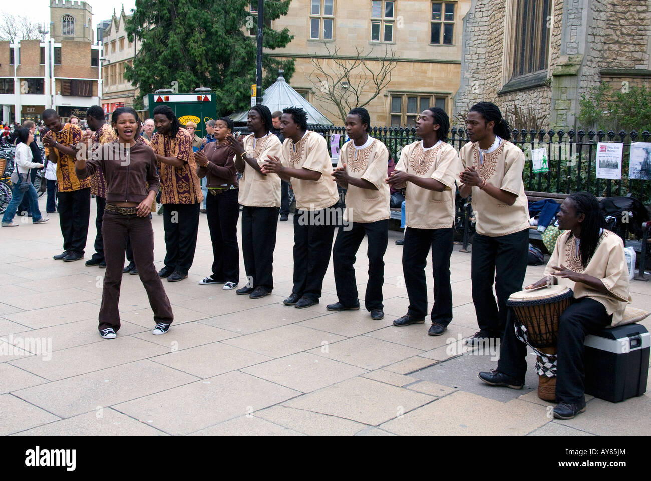 A group of African singers and dancers busking in a Cambridge street ...