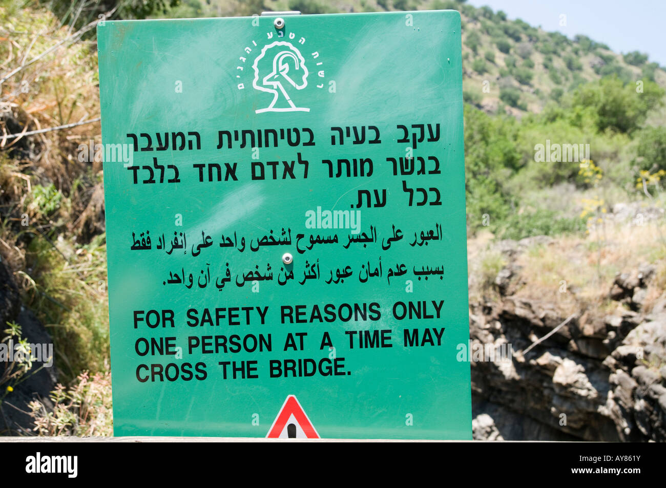 A sign - Only one person at a time may cross the bridge Stock Photo - Alamy