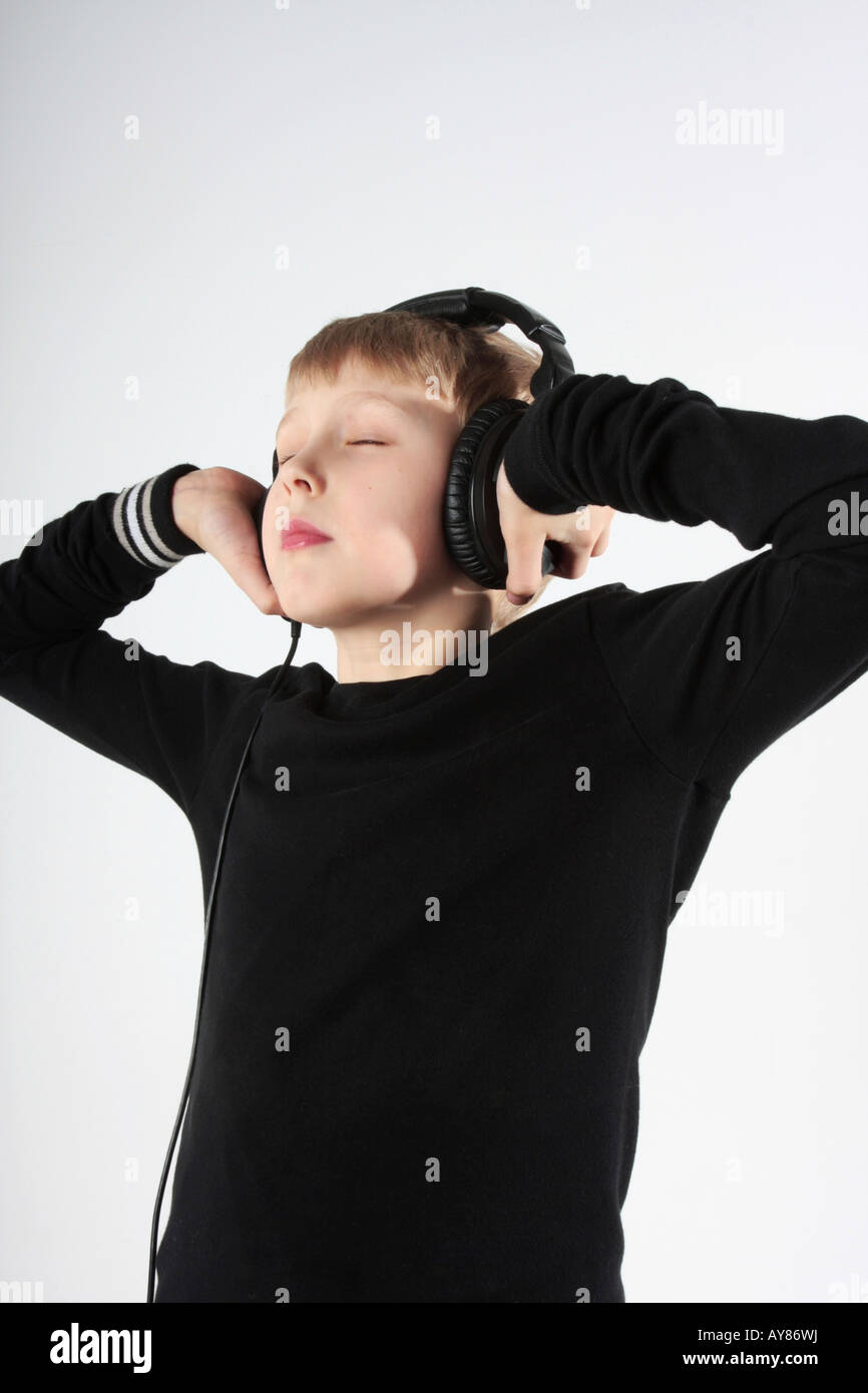 Young boy listening to music in headphones Stock Photo - Alamy
