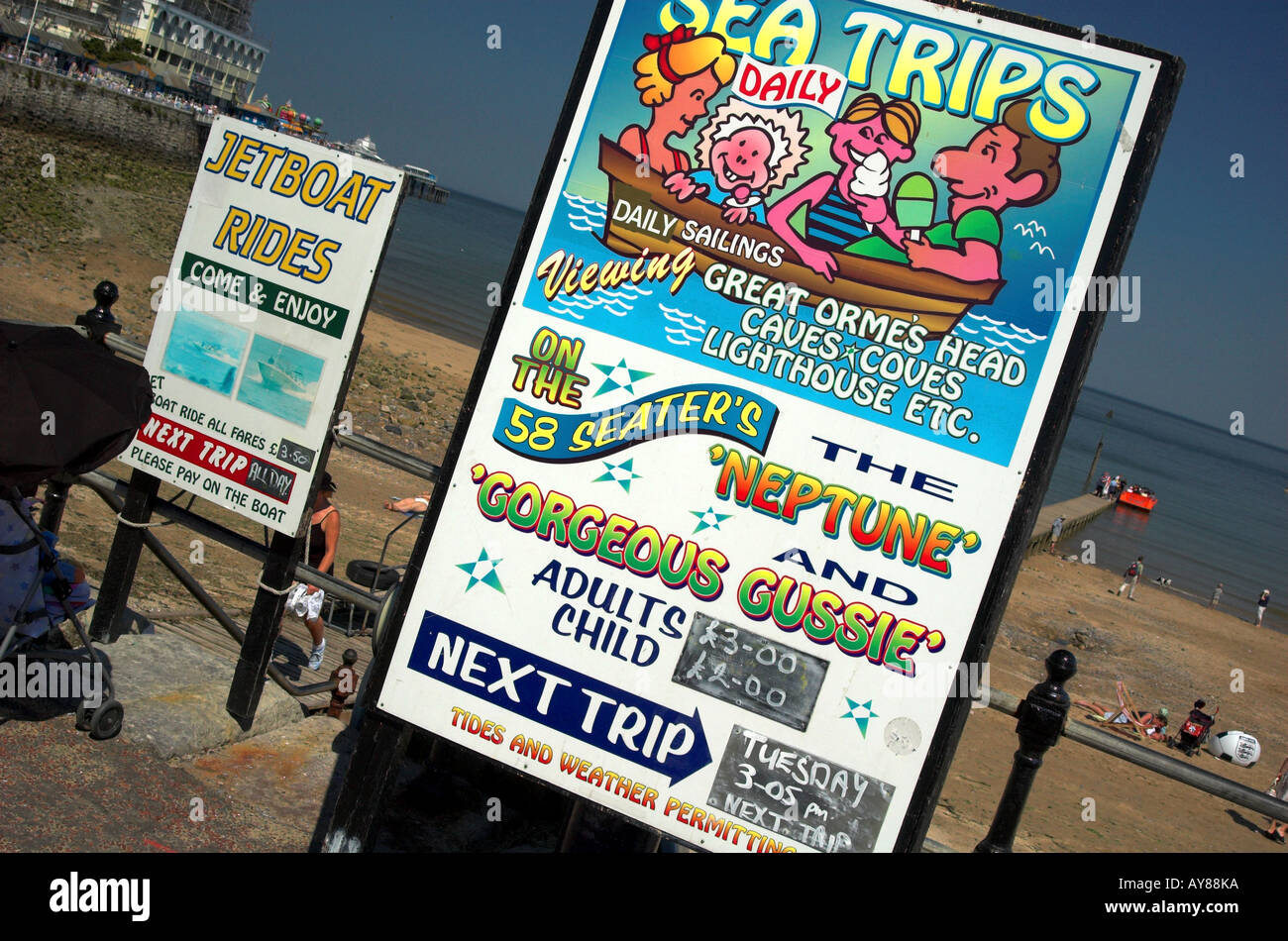 Notice board advertising boat trips, Llandudno, North Wales Stock Photo ...