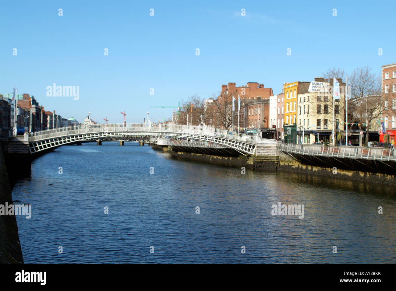Pedestrian Halfpenny Bridge which crosses the River Liffey in Dublin ...