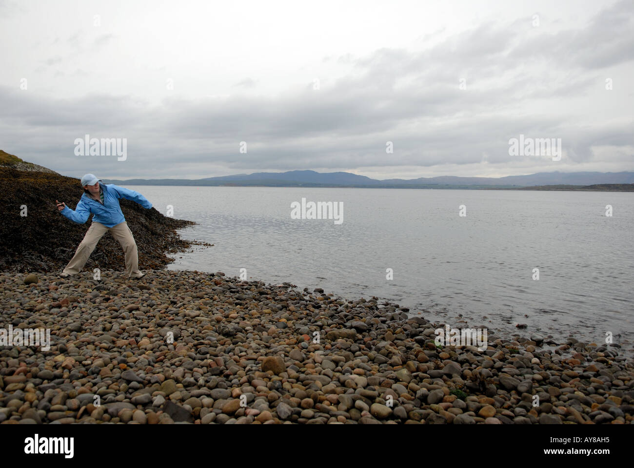 Young Girl Throwing stone Stock Photo - Alamy