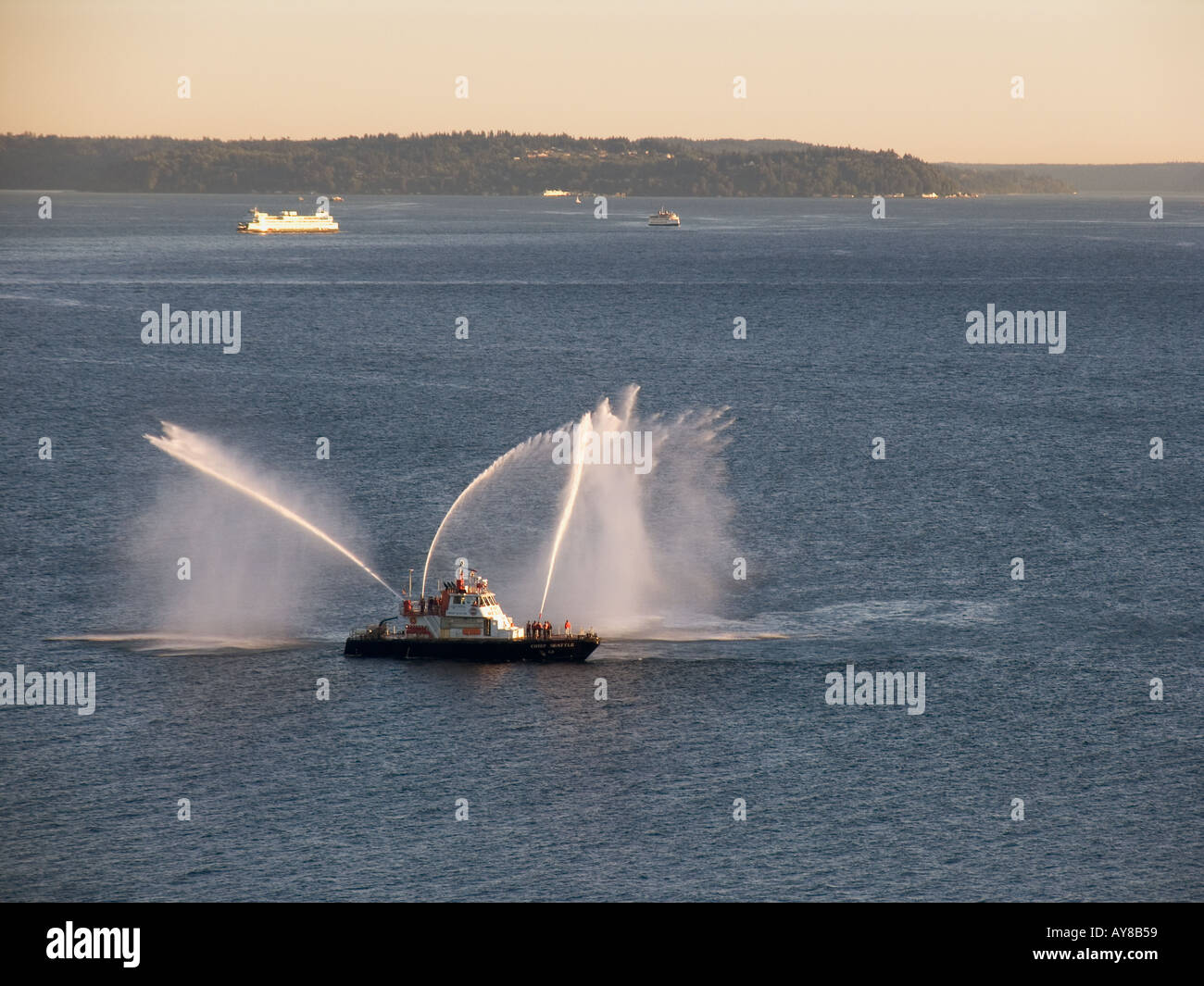 Fireboat spraying water from fire nozzles in Puget Sound Seattle ...