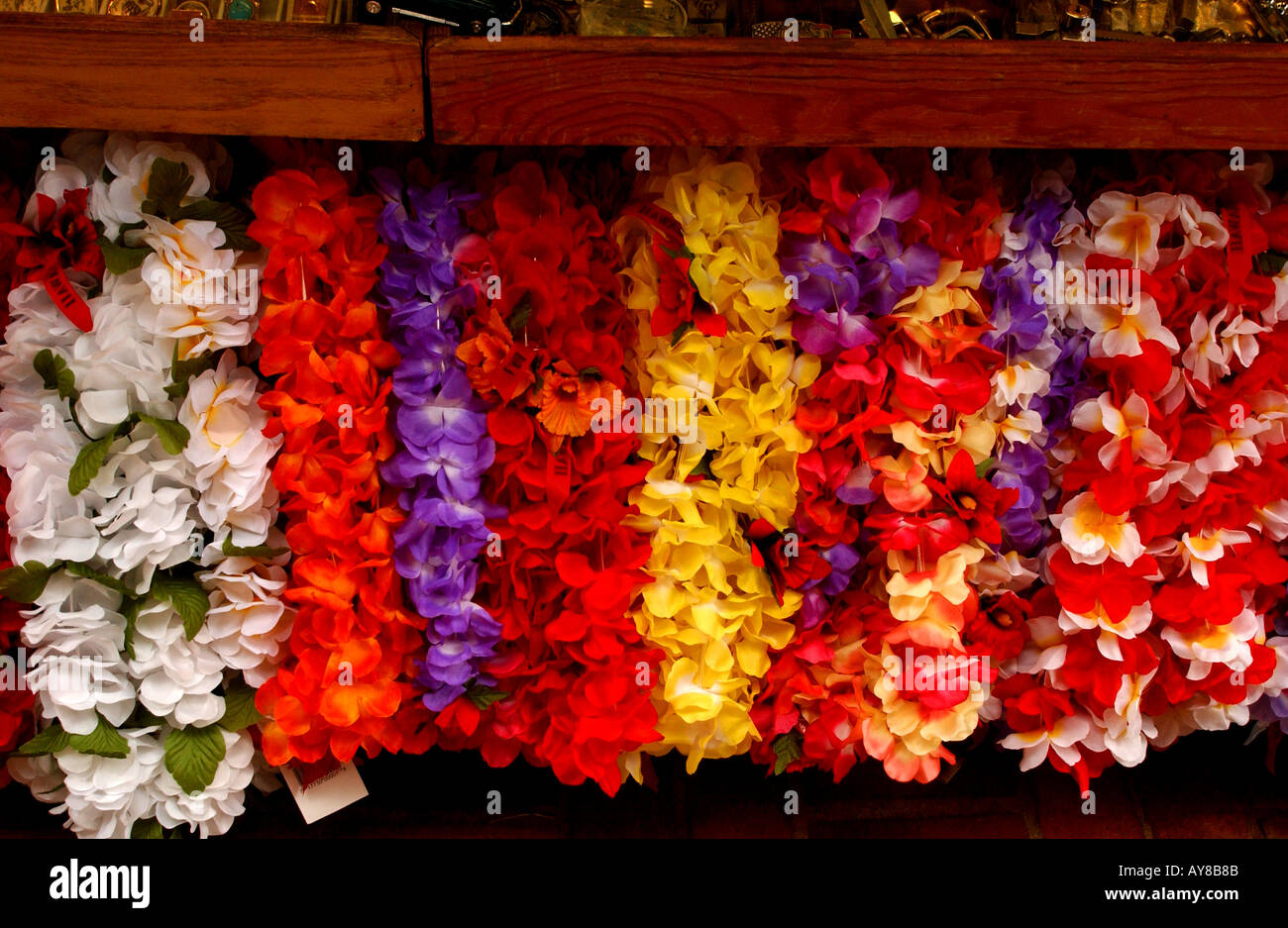 Color image of brightly color lei s on display at a shop in Waikiki on ...