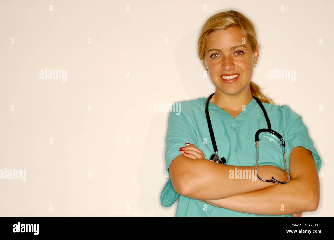 Vertical color image of an attractive blonde female nurse or doctor ...