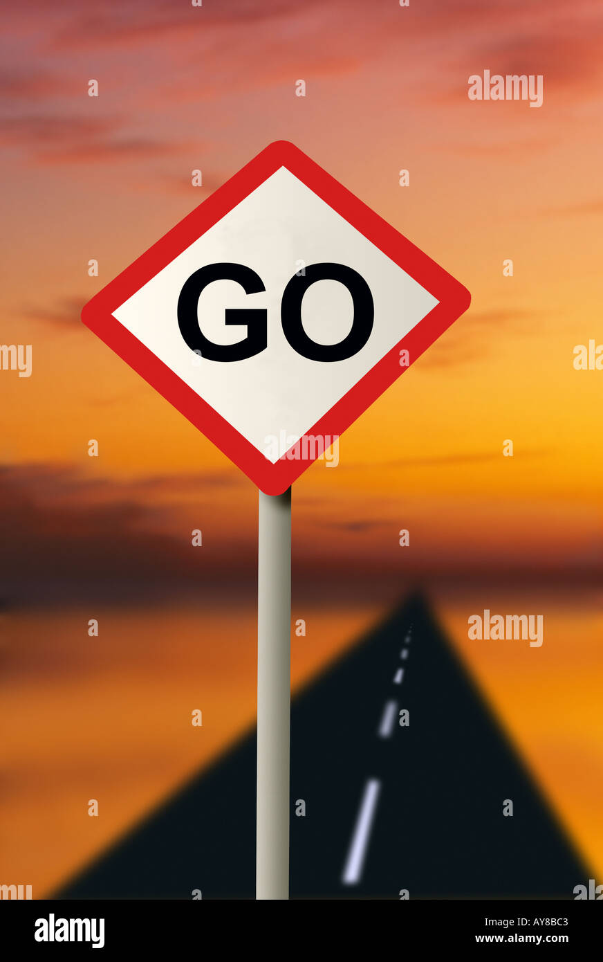 Road traffic sign with Go logo and straight road towards the horizon ...