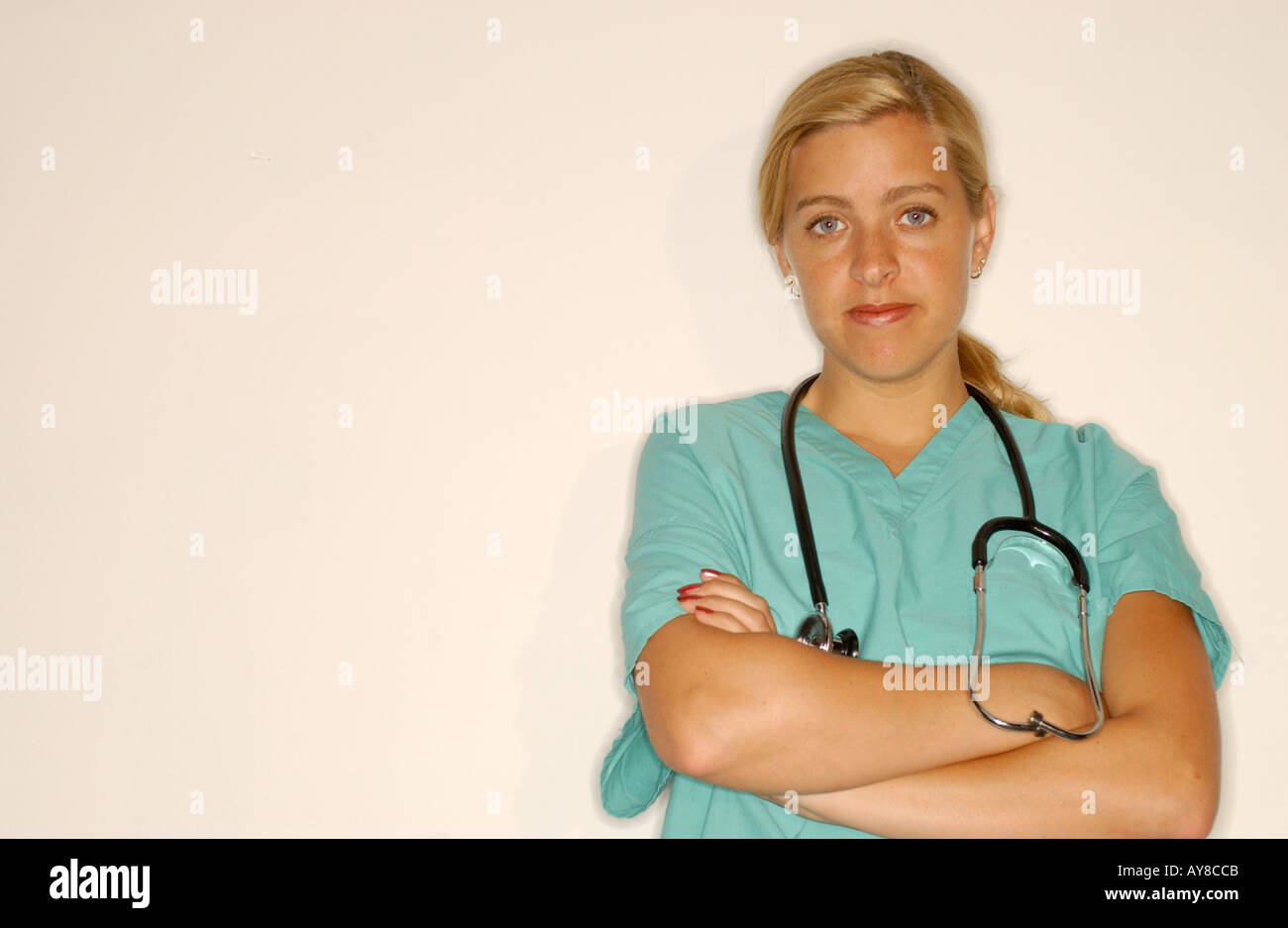 Vertical color image of an attractive blonde female nurse or doctor ...