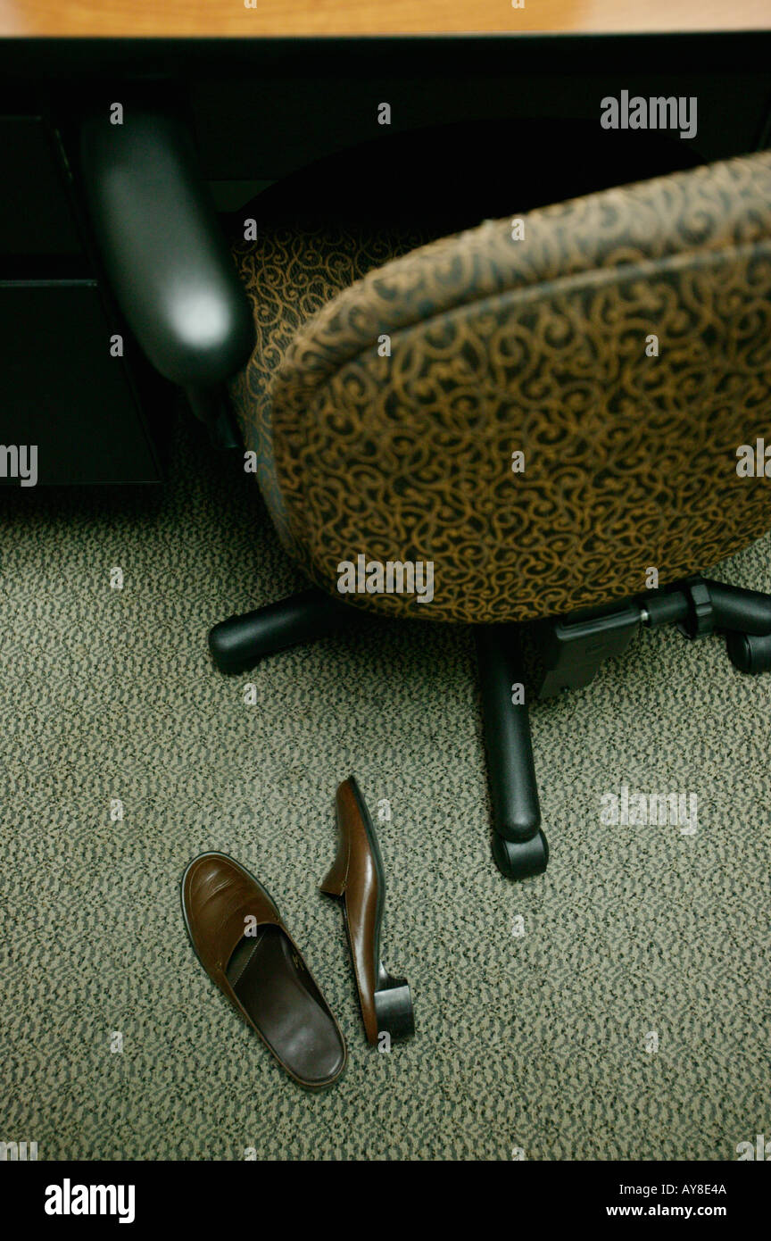 Female employee s shoes at side of desk and chair Stock Photo - Alamy