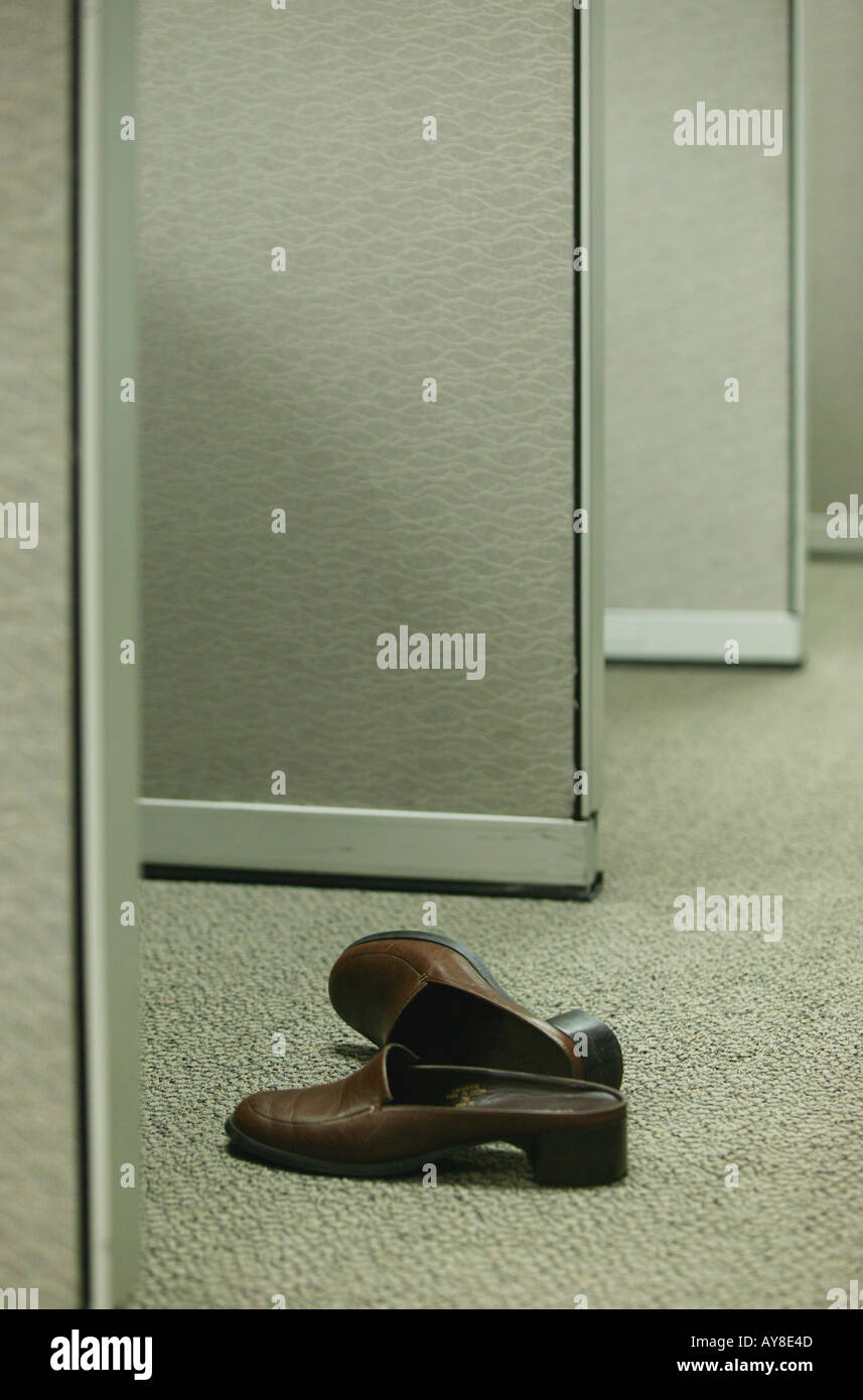 Male employee shoes outside small cubicle in highrise office building ...