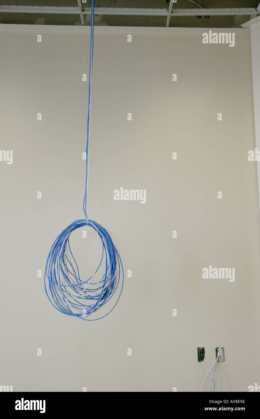 Ethernet cable hangs from ceiling awaiting installation during office ...