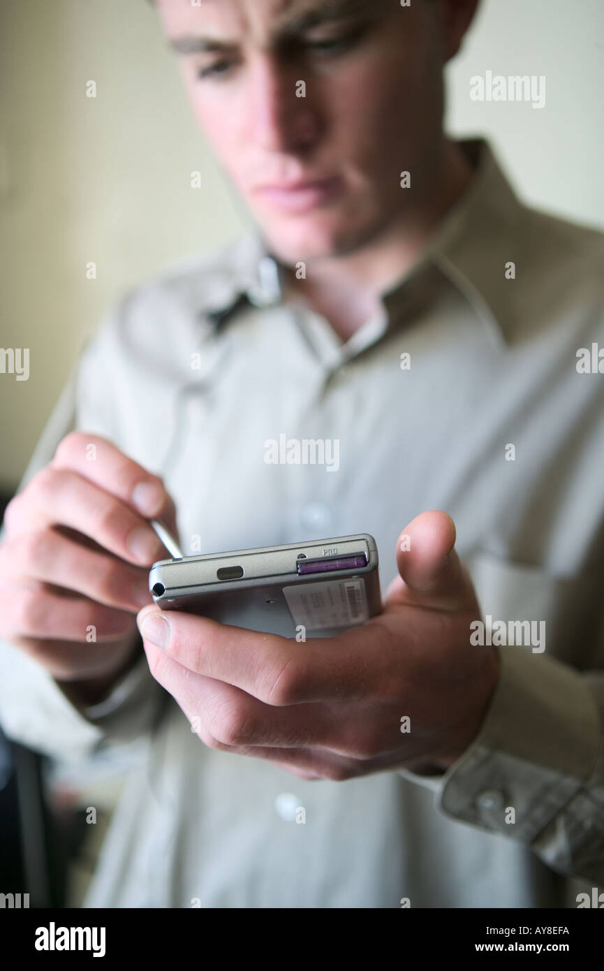 Young man using PDA Stock Photo - Alamy