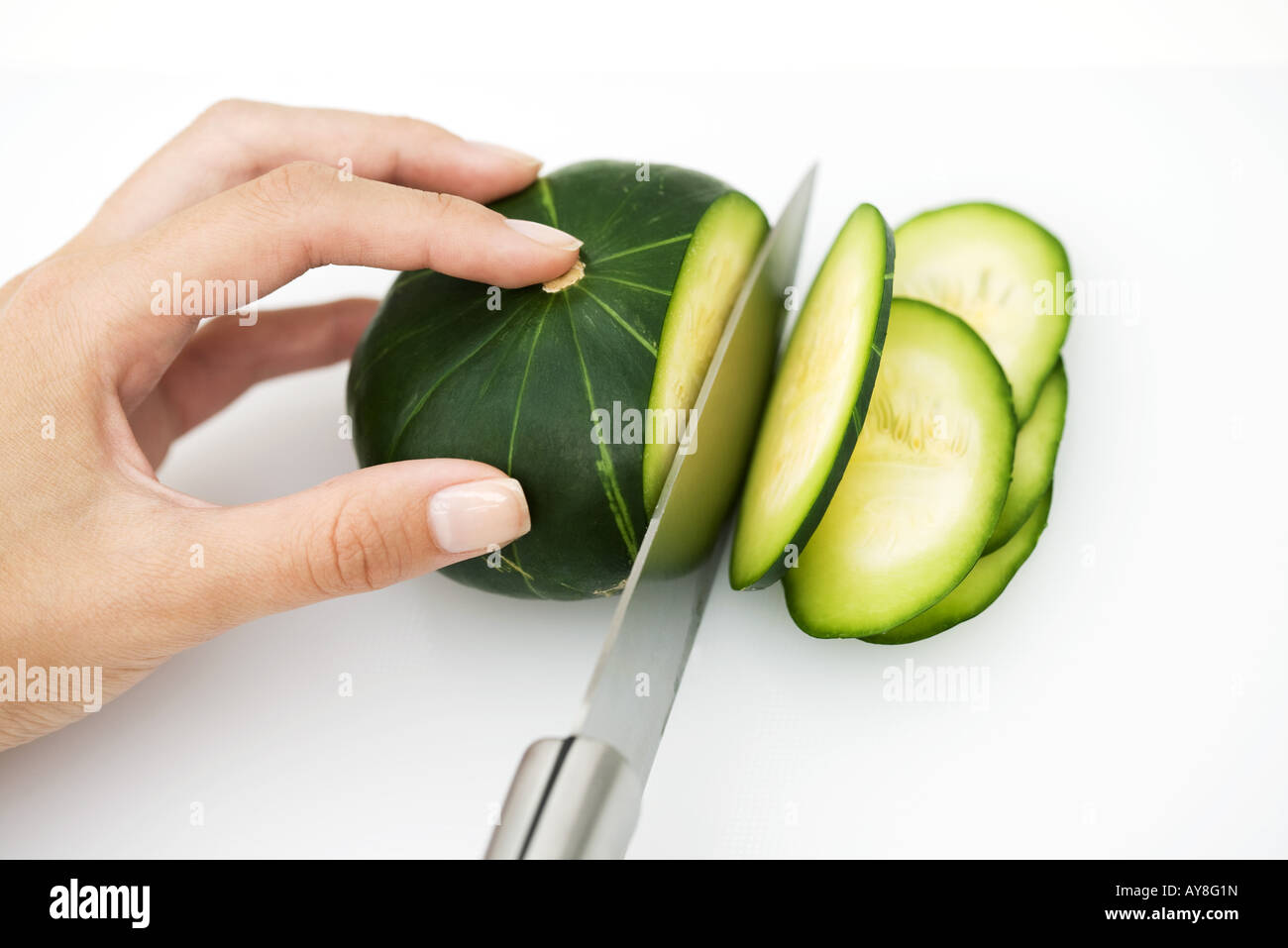 Woman slicing squash with knife, cropped view of hand Stock Photo - Alamy