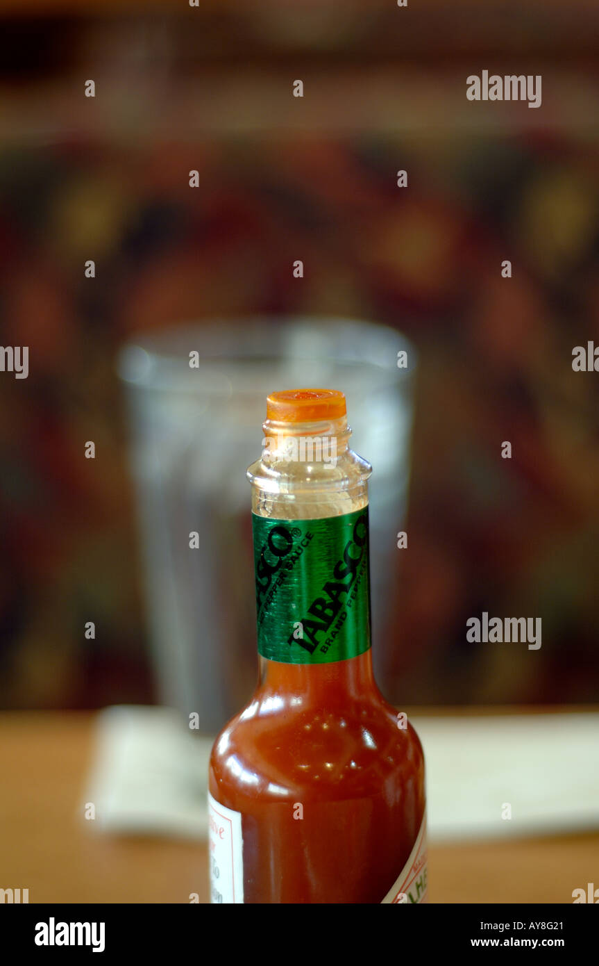 Glass of water and Tabasco sauce on restaurant table Stock Photo - Alamy