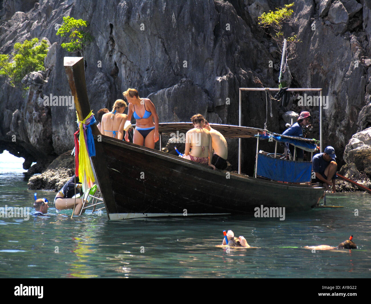 Young people snorkelling from longtail boat Ko Ma island near Ko Ngai ...