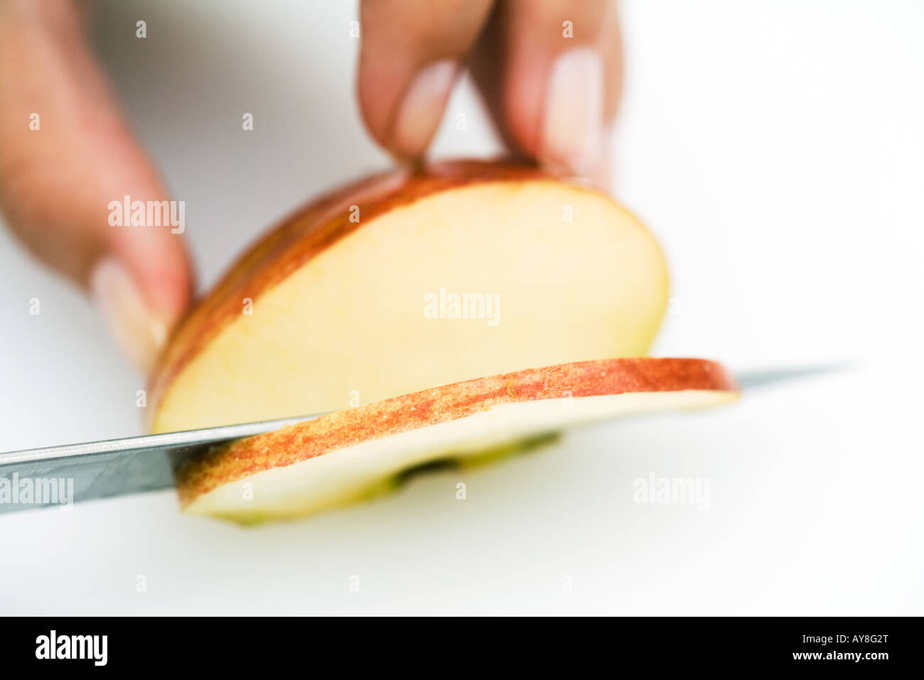 Woman slicing apple with knife, cropped view of hand Stock Photo - Alamy