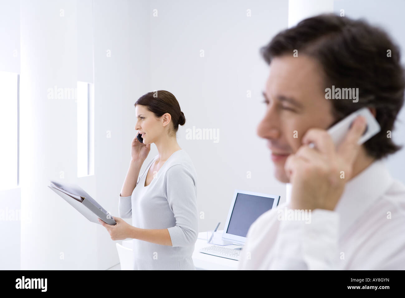 Business people in office using cell phones Stock Photo - Alamy