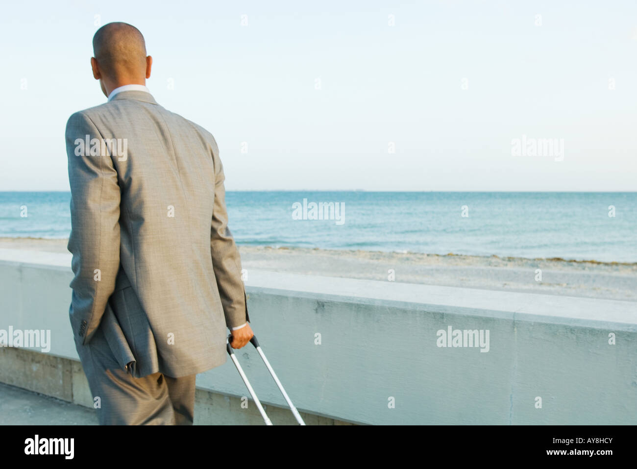 Beach pulling suitcase hi-res stock photography and images - Alamy