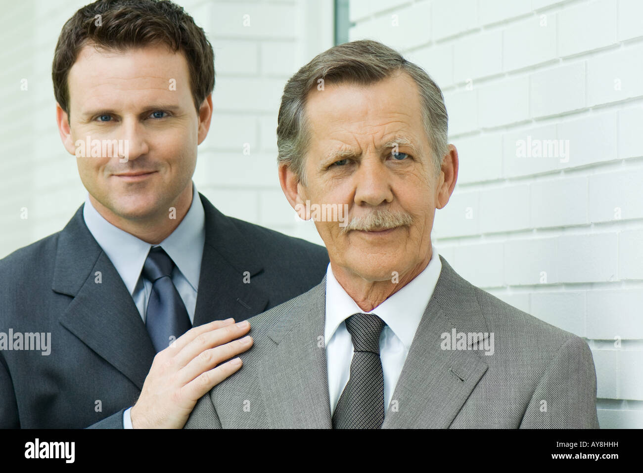 Two businessmen smiling at camera, portrait Stock Photo - Alamy