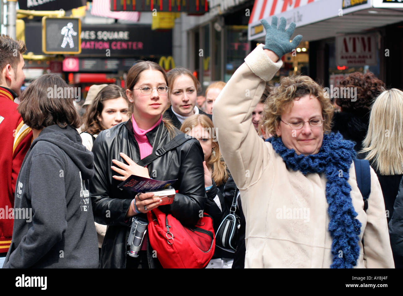 female tour guide leading group of female tourists near Times Square ...