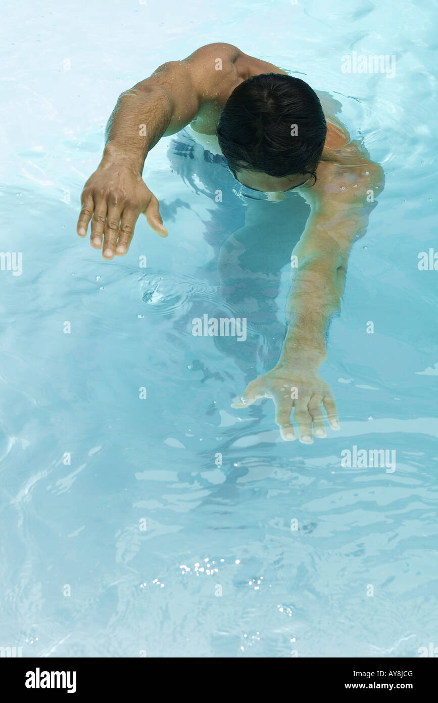 Man swimming in pool, arms out, head down Stock Photo - Alamy