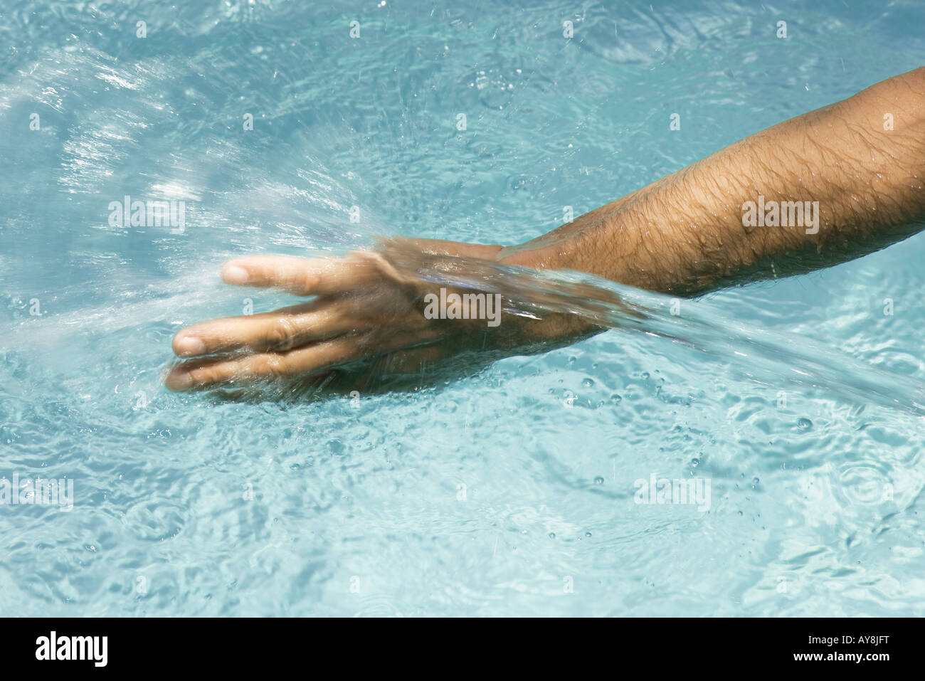 Man splashing in swimming pool, cropped view of arm Stock Photo - Alamy
