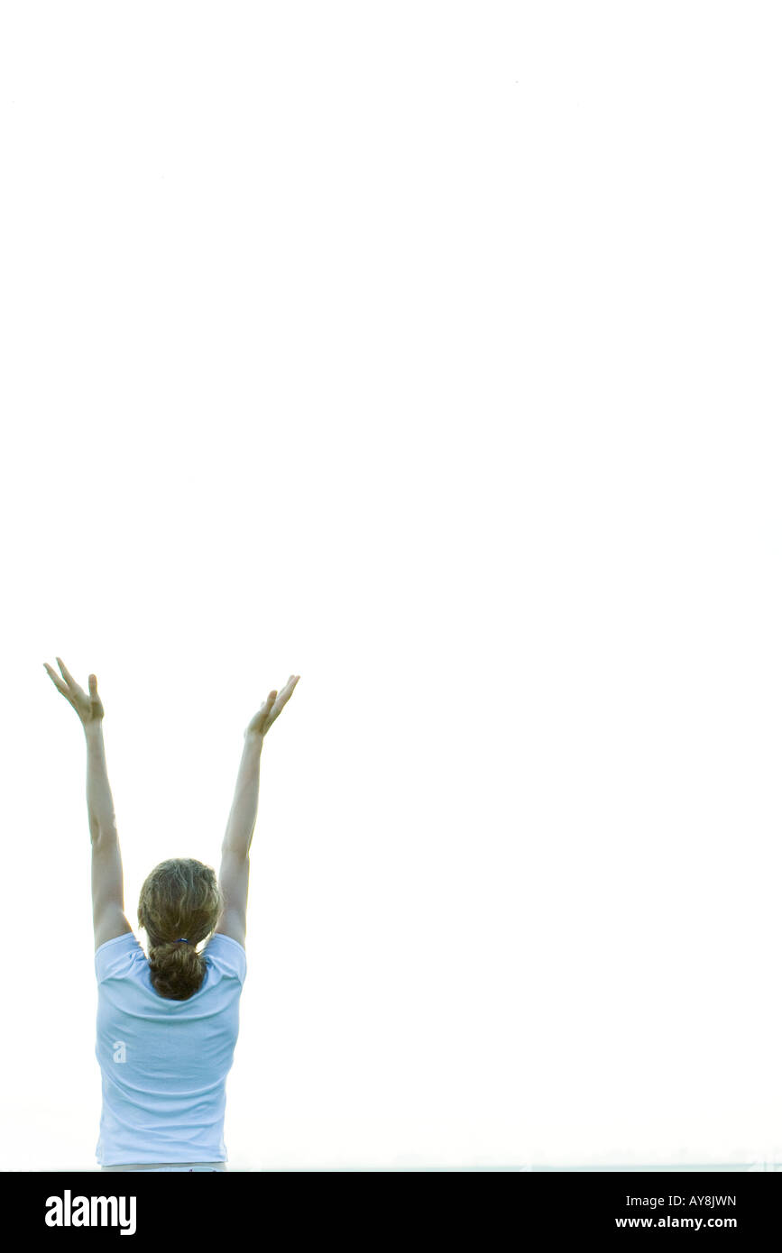 Teenage girl with arms raised, rear view Stock Photo - Alamy