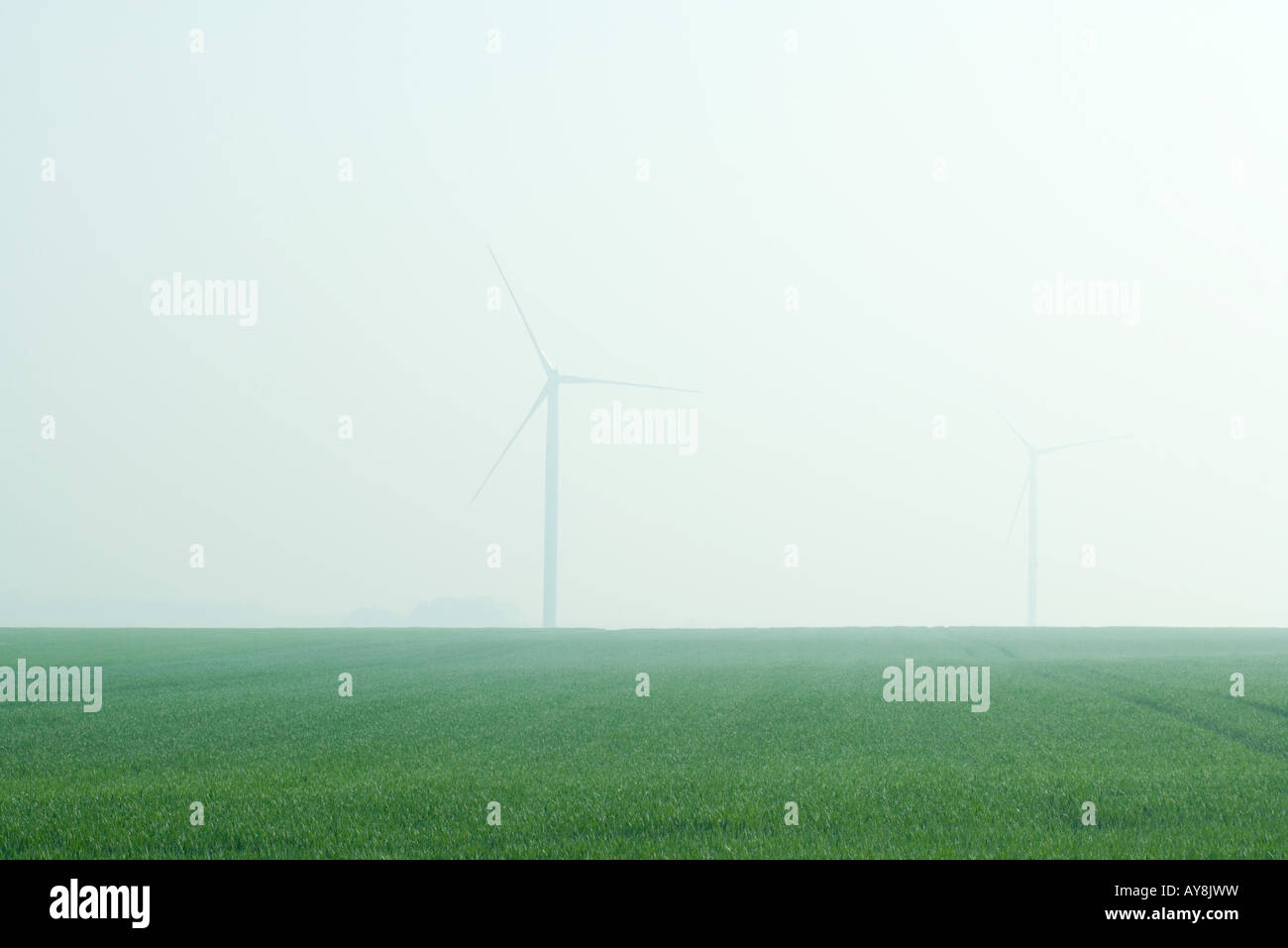 Wind turbines in foggy landscape Stock Photo - Alamy