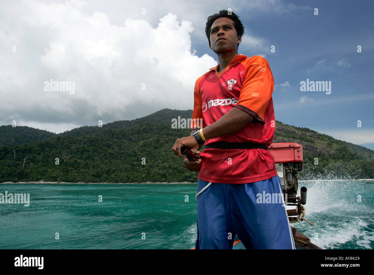 Longtail captain steering boat under way Thailand Stock Photo - Alamy