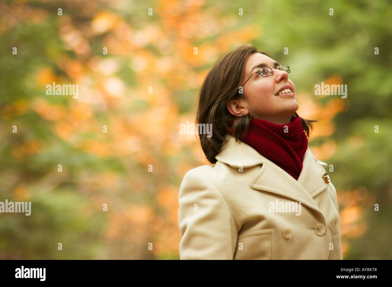 Young women looking upwards with a colorful background Stock Photo - Alamy