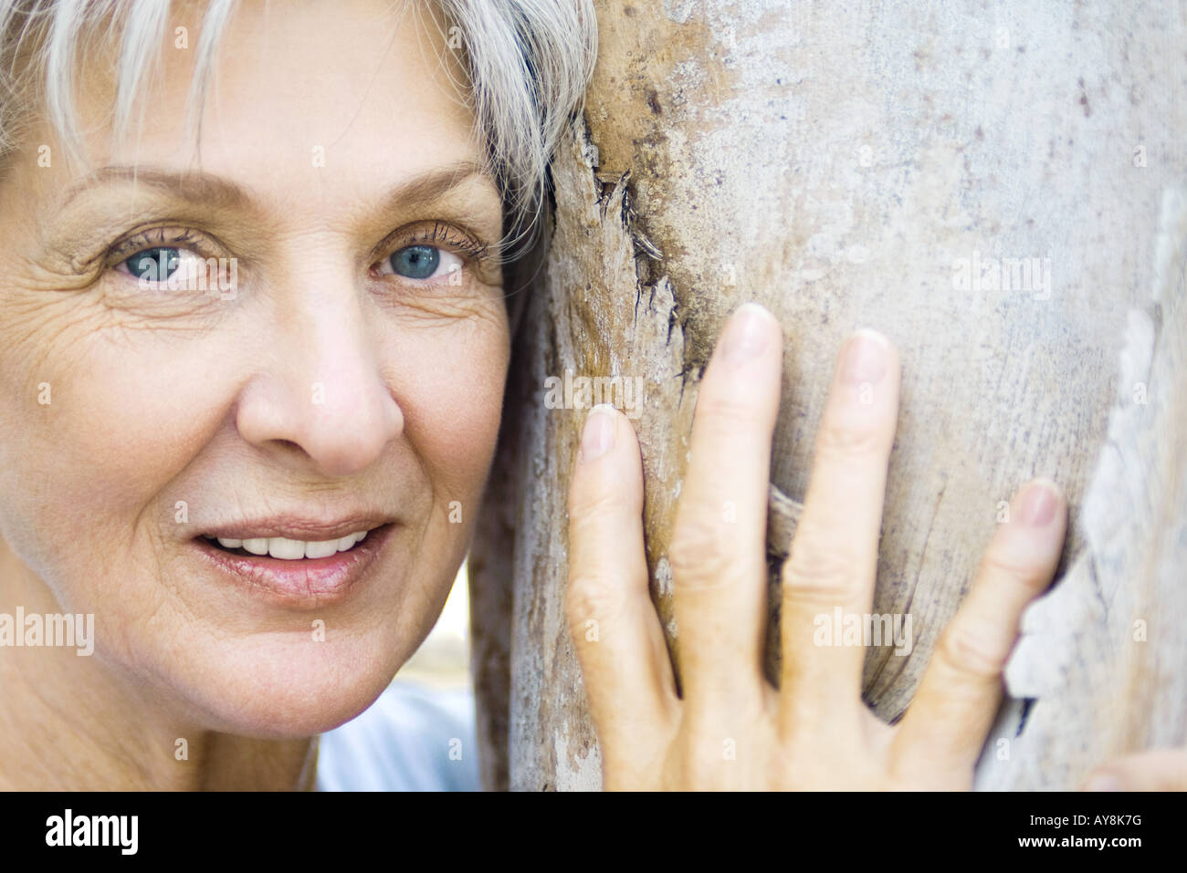 Senior woman leaning against tree hi-res stock photography and images ...