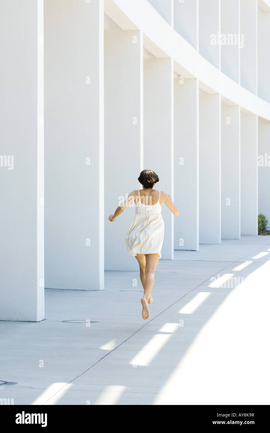 Woman in sundress running outdoors, rear view Stock Photo - Alamy