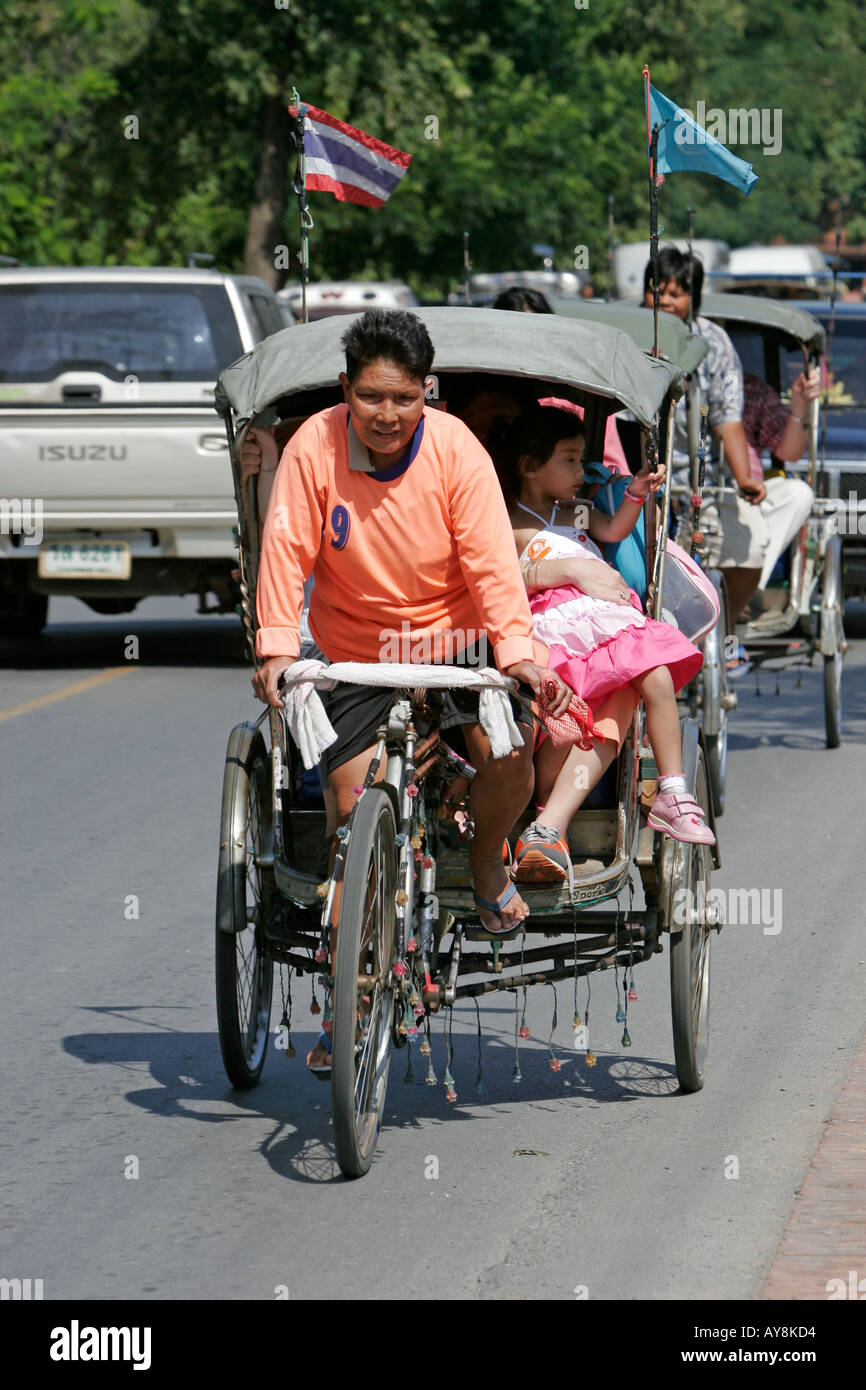 Visitors ride in bicycle rickshaw Ayutthaya Thailand Stock Photo - Alamy