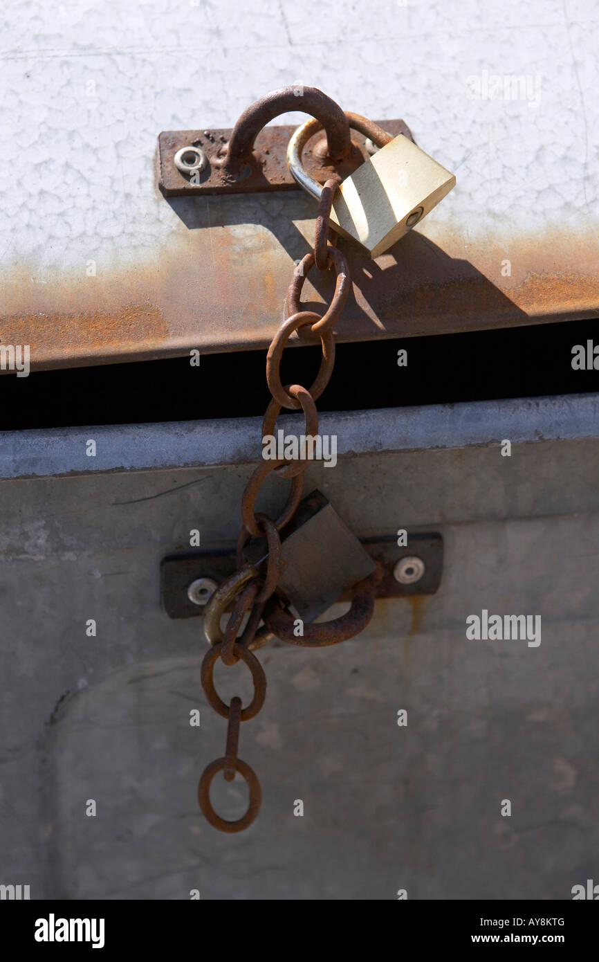 A lock and chain holding a garbage bin closed Stock Photo - Alamy