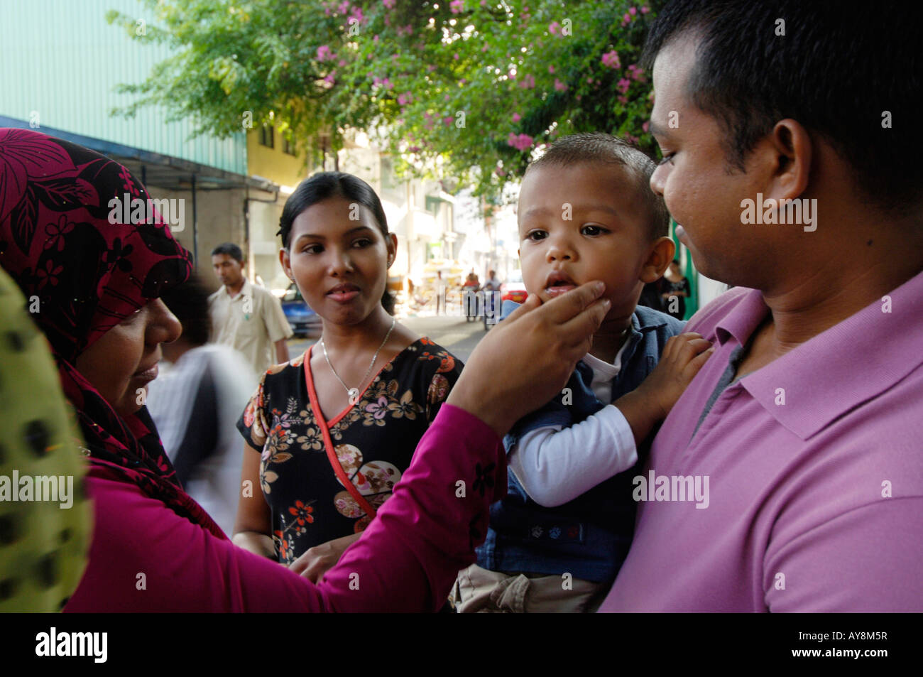 a child being the center of attraction on a street of Male Maldives ...