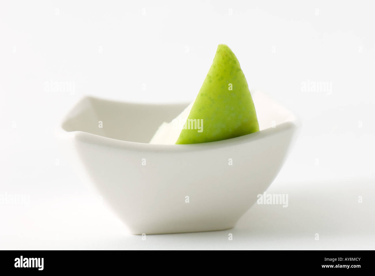 Apple slice in small dish, close-up Stock Photo - Alamy