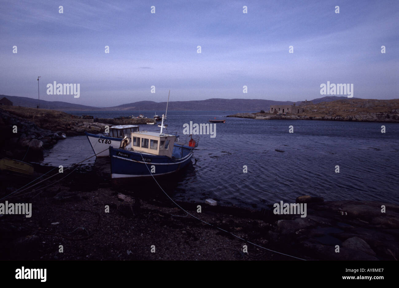 Boat in the harbour of the Isle of Eriskay in the Outer Hebrides or ...