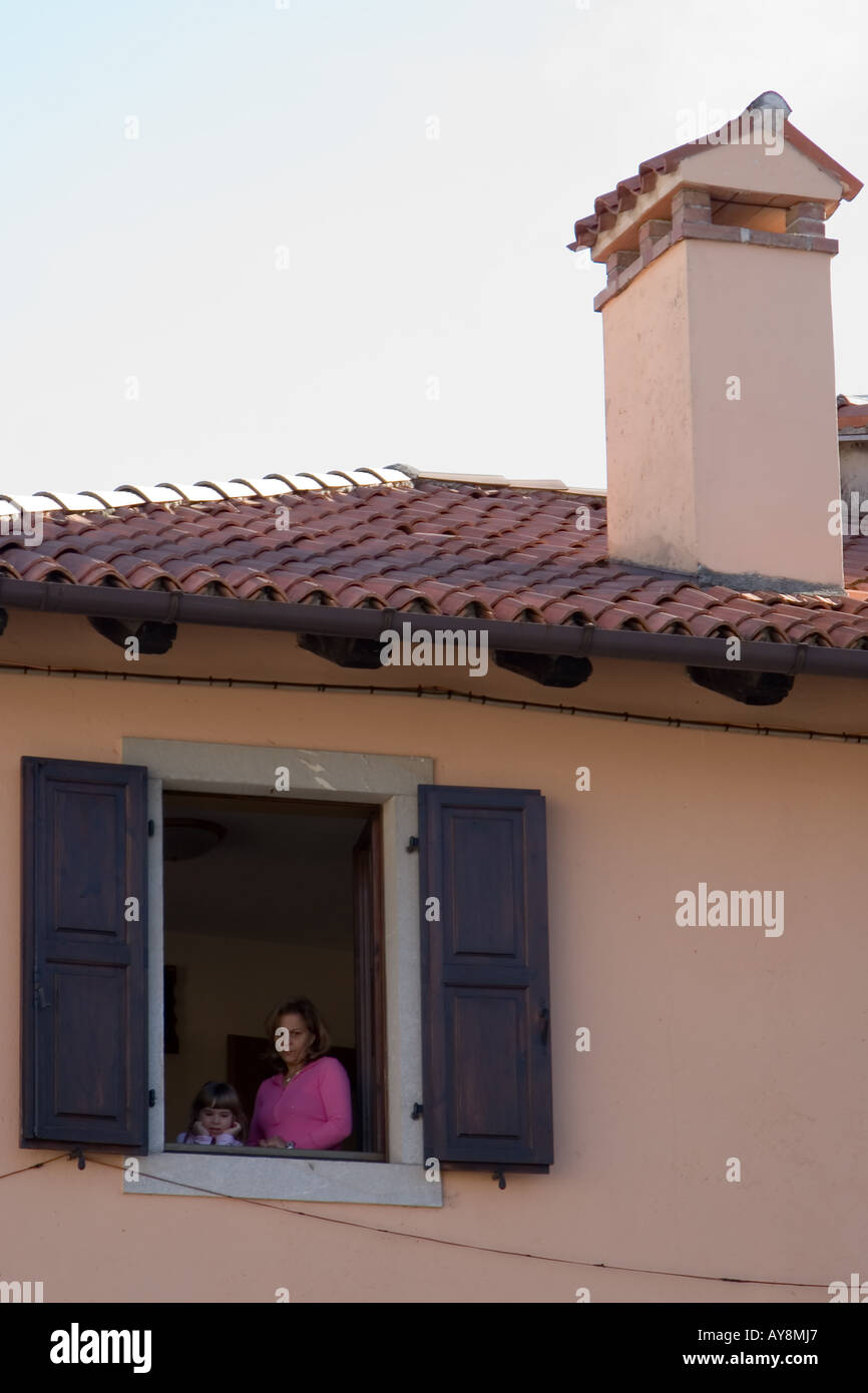 Stock Photo of A Mother and a Daughter Watching a Parade Through a ...