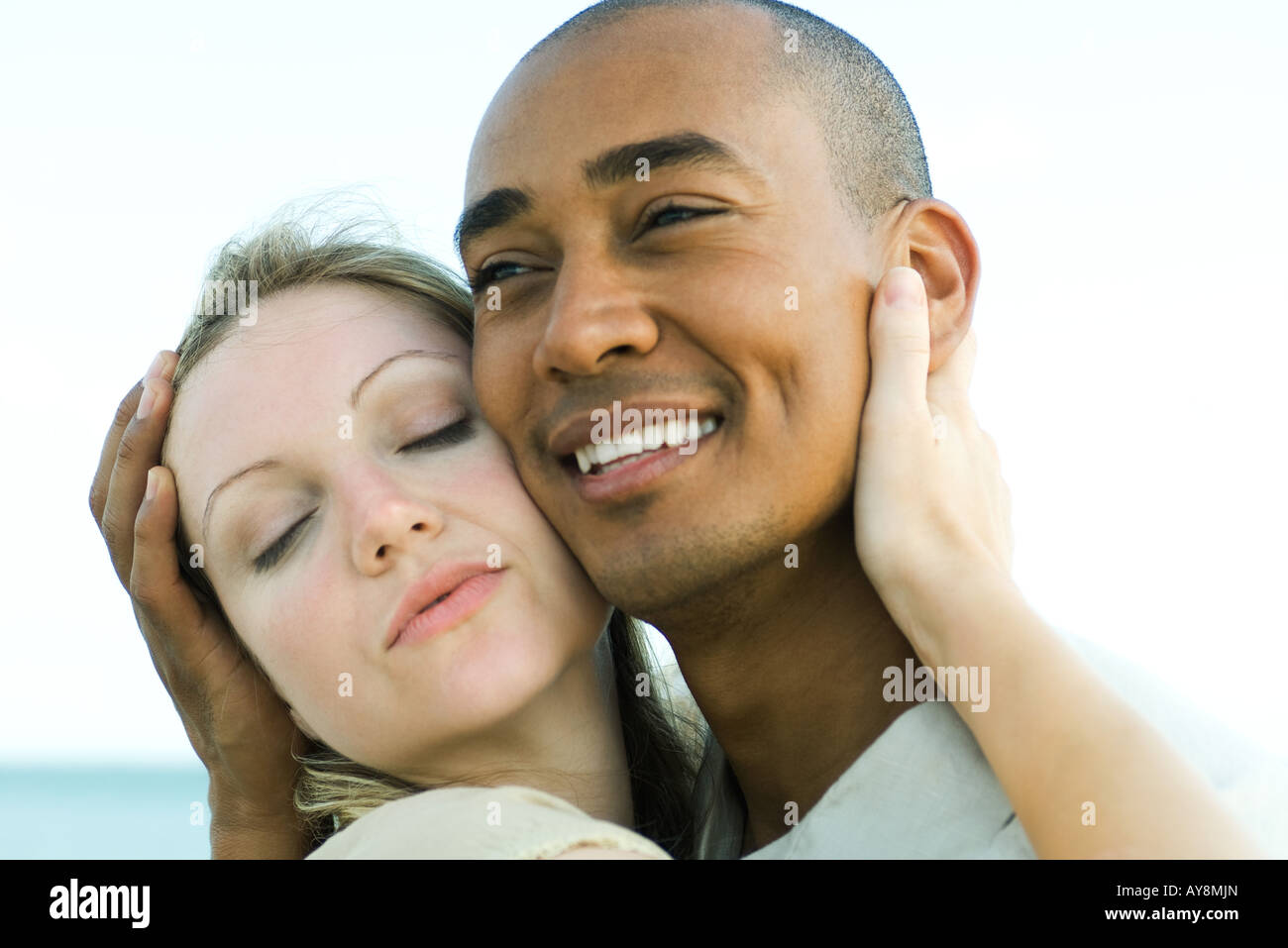 Couple embracing, cheek to cheek, close-up Stock Photo - Alamy
