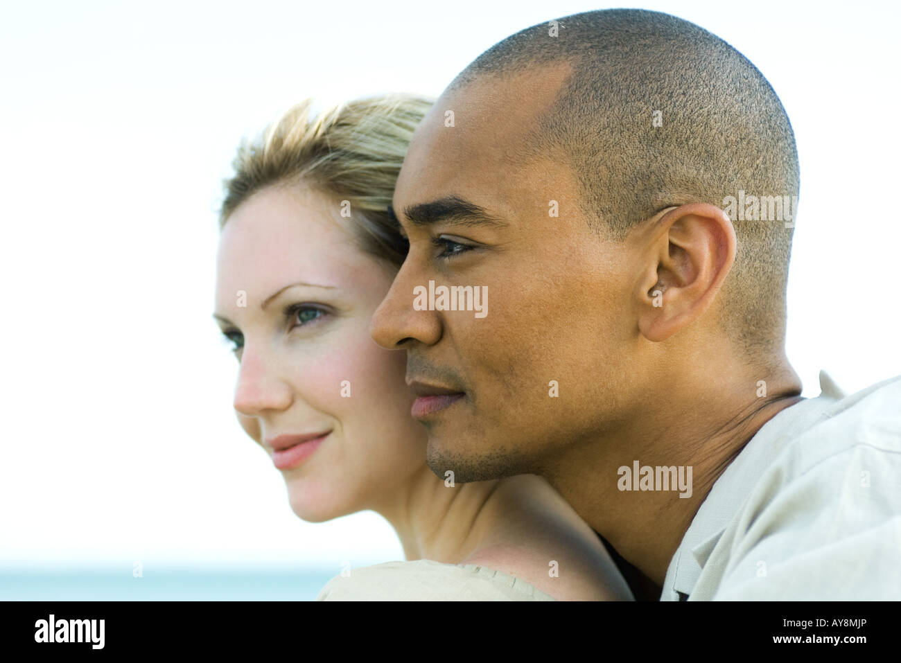 Couple cheek to cheek, looking away together, profile Stock Photo - Alamy