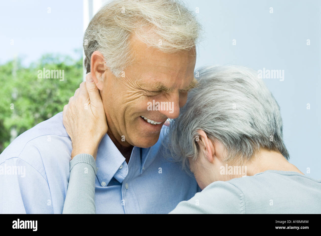 Mature woman leaning her head on husband's chest, close-up Stock Photo ...