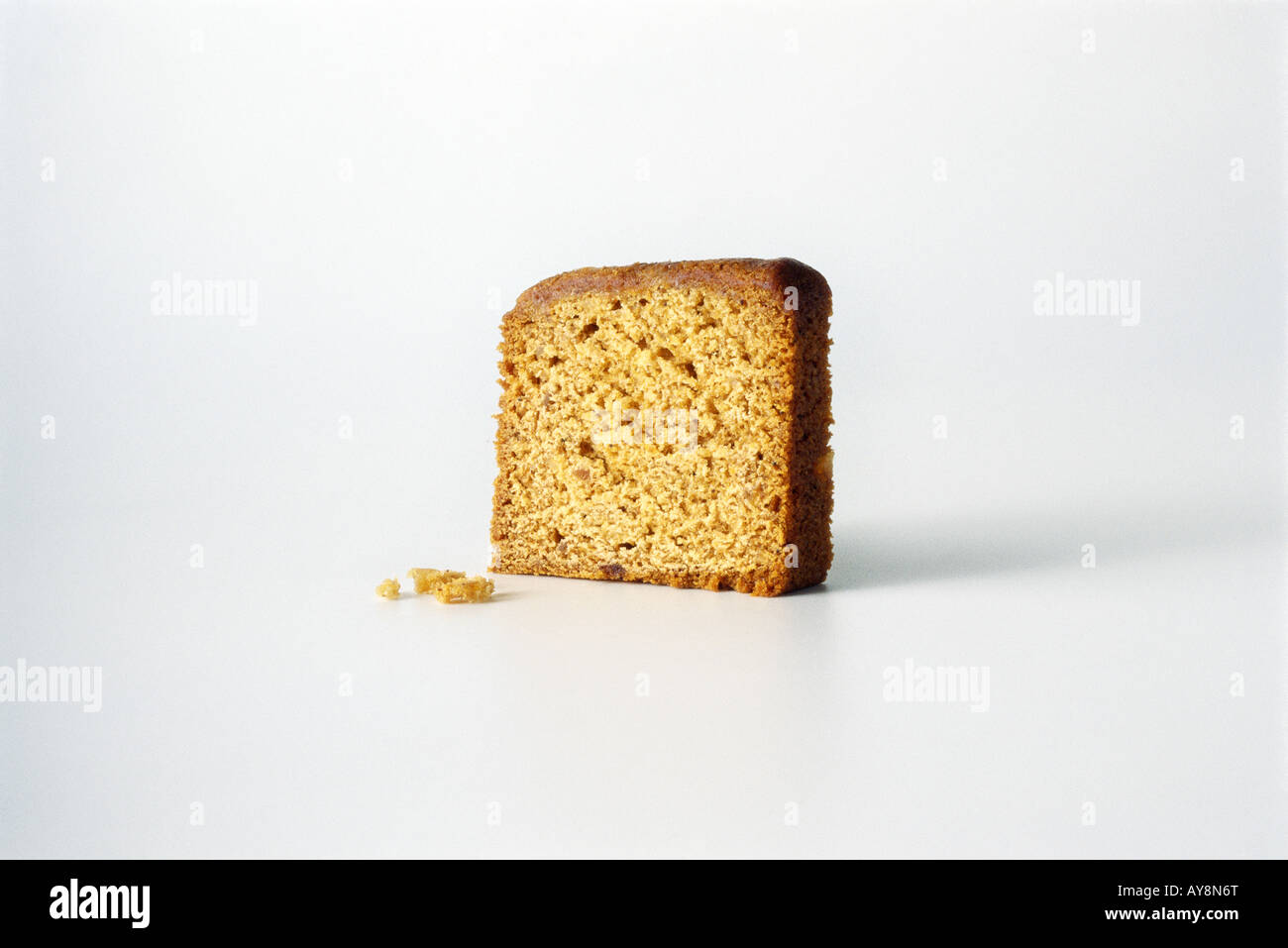 Slice of bread and crumbs, white background Stock Photo - Alamy