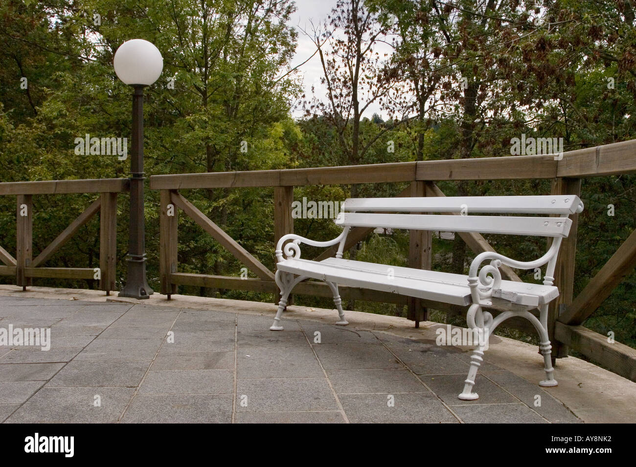 A white bench a brown fence and a lamp post Shot October 2006 Stock ...