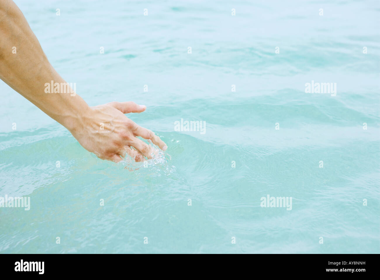 Hand touching water, close-up Stock Photo - Alamy