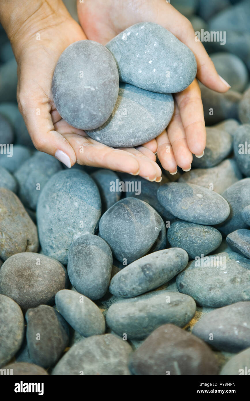 Hands holding pebbles, close-up Stock Photo - Alamy